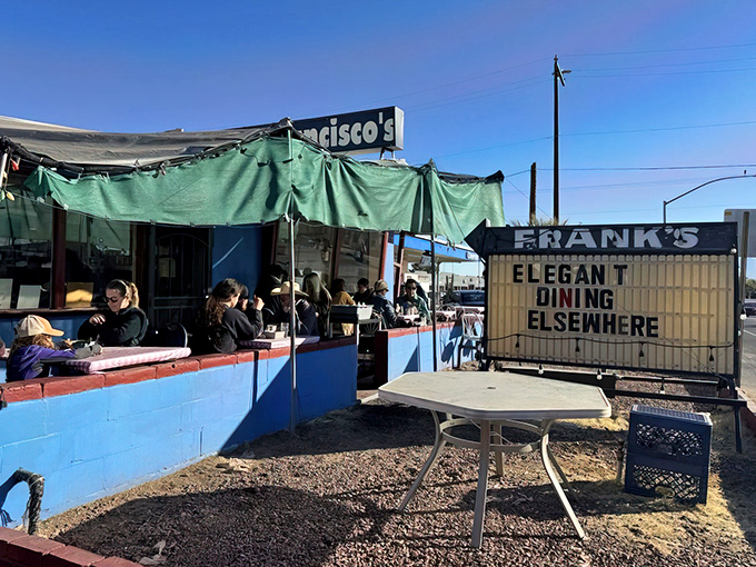 The blue walls and green tarps create a no-frills oasis where locals gather to enjoy what really matters: seriously good food without pretension.