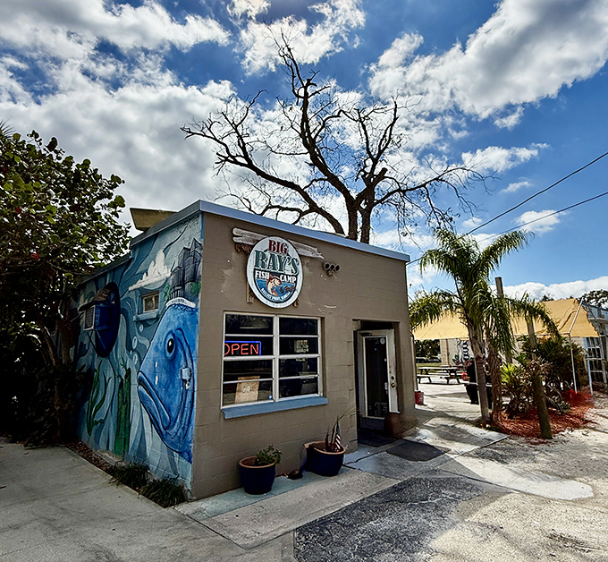 The side mural proves that even fish camps can have artistic ambitions beyond perfectly fried seafood.