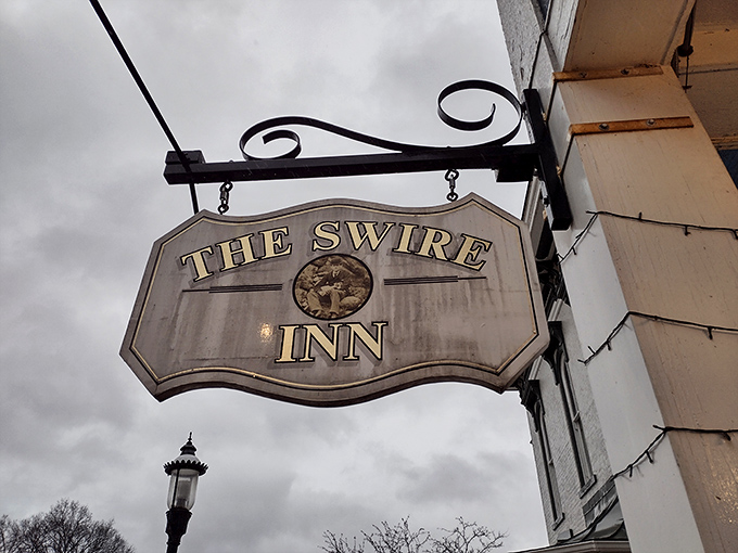 That classic hanging sign—the universal symbol for "good things happen inside"—beckons hungry travelers to step into The Swire Inn's welcoming embrace.