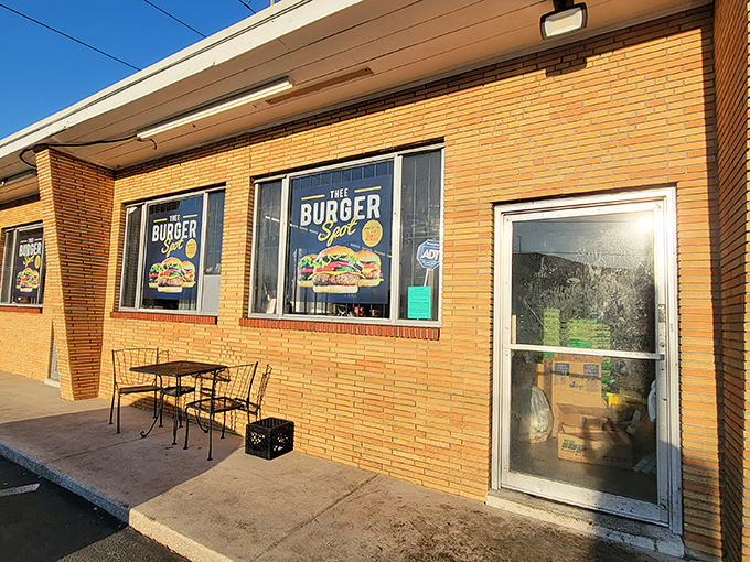 The golden-bricked exterior of Thee Burger Spot beckons like a temple of comfort food, promising affordable deliciousness behind its unassuming fa&ccedil;ade.