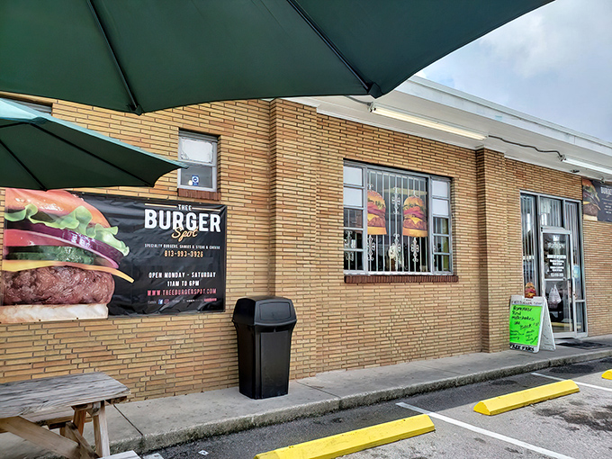 The unassuming yellow brick exterior of Thee Burger Spot stands like a culinary fortress, promising treasures that no fancy architecture could ever outshine.