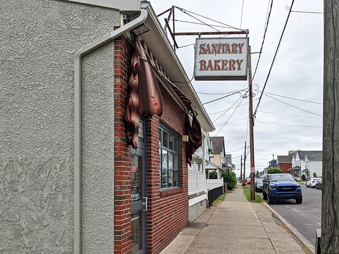 The unassuming brick-and-stucco exterior of Sanitary Bakery stands like a sweet sentinel in Nanticoke, promising delicious treasures within. No fancy frills needed.
