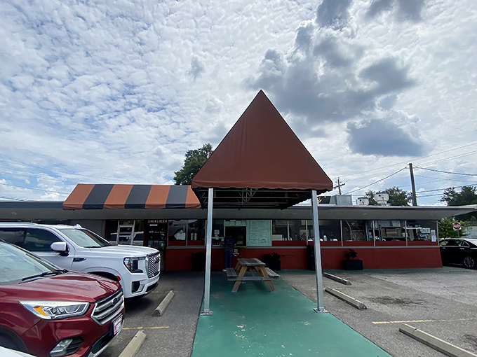 The distinctive orange and gray striped awning of Jimbo's stands like a barbecue beacon, promising smoky delights within this unassuming Lakeland landmark.