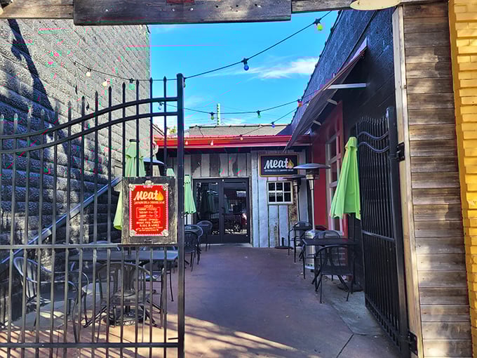 Welcome to meat paradise! The unassuming entrance to Meat BBQ in Lansing beckons carnivores through its wrought-iron gate with a promise of smoky delights ahead.