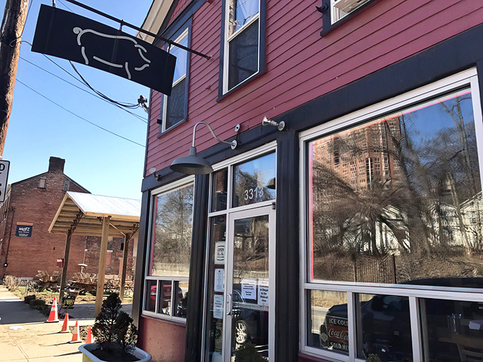 The unassuming pink exterior of Eli's BBQ might fool you, but that pig silhouette sign is basically a smoke signal saying "food paradise ahead."