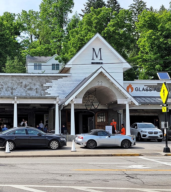 The distinctive white exterior of M Italian stands like a culinary beacon in Chagrin Falls, inviting hungry travelers with its charming farmhouse-inspired architecture and welcoming porch.