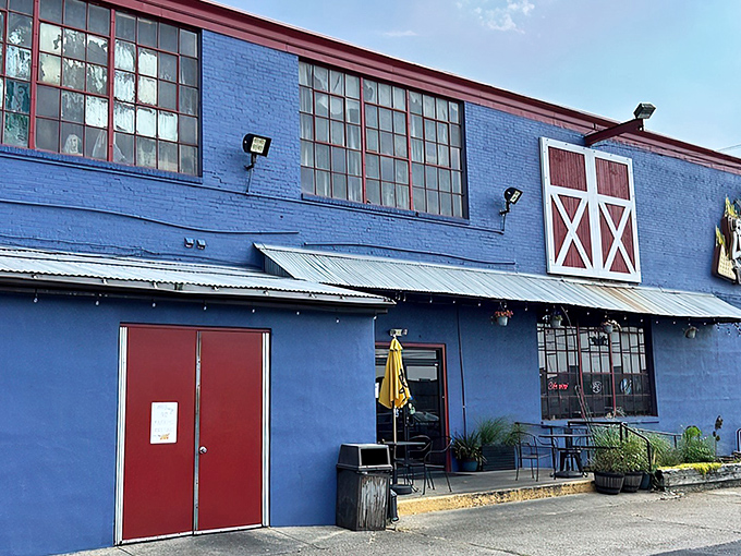 The bright blue exterior of Sweet Lucy's stands out like a delicious mirage, promising smoky treasures within those barn-inspired walls.