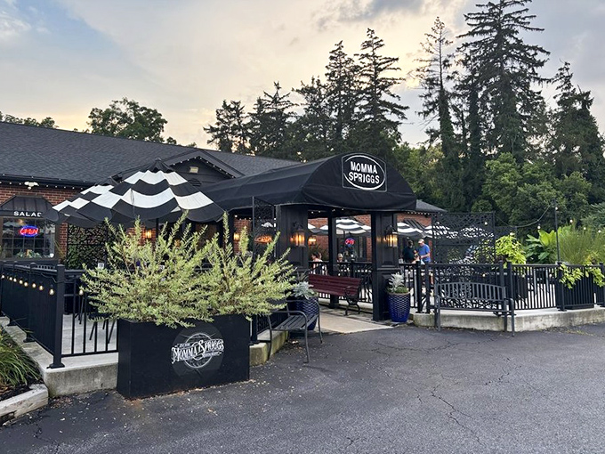 Twilight transforms Momma Spriggs into a beacon of culinary promise, with string lights twinkling like stars guiding hungry travelers to this brick-faced sanctuary of comfort food.