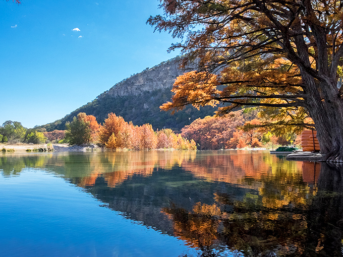 Fall's masterpiece reflects perfectly in the Frio River, creating nature's own Instagram filter that no phone app could ever replicate.