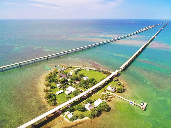 Where the sky meets the sea meets engineering marvel&mdash;the Seven Mile Bridge stretches across impossibly turquoise waters, with Pigeon Key nestled like a green jewel below.