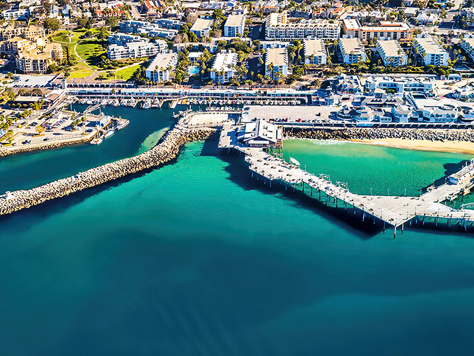 The marina's horseshoe shape creates a perfect turquoise embrace, like Mother Nature designed her own infinity pool with boats.
