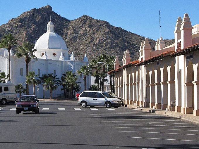 The Immaculate Conception Catholic Church stands like a pristine wedding cake against Ajo's rugged mountains, proving that desert architecture doesn't have to be fifty shades of beige.