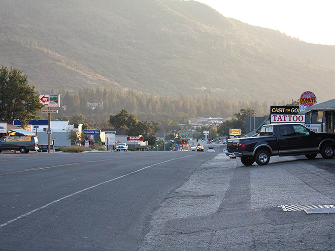 Main Street Oakhurst stretches toward pine-covered mountains like nature's welcome mat. Small-town charm with big mountain views.