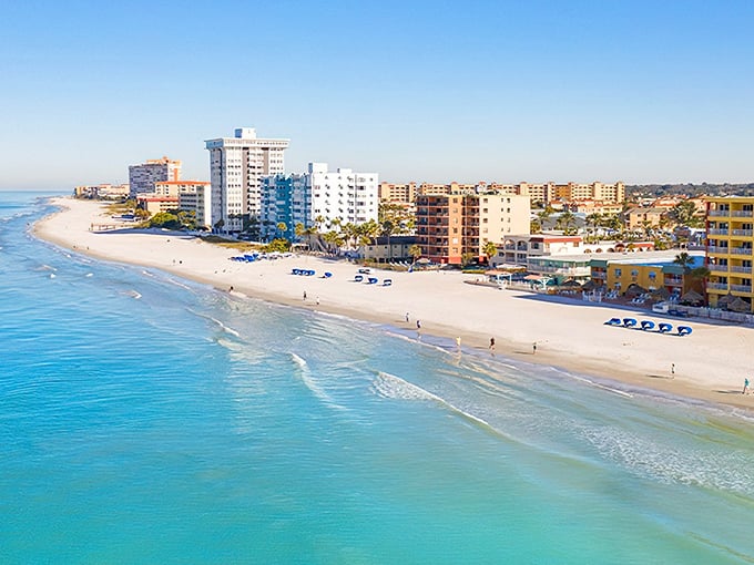 Turquoise waters meet pristine white sand along Redington Beach's shoreline, where mid-rise condos stand like sentinels guarding Florida's best-kept secret.