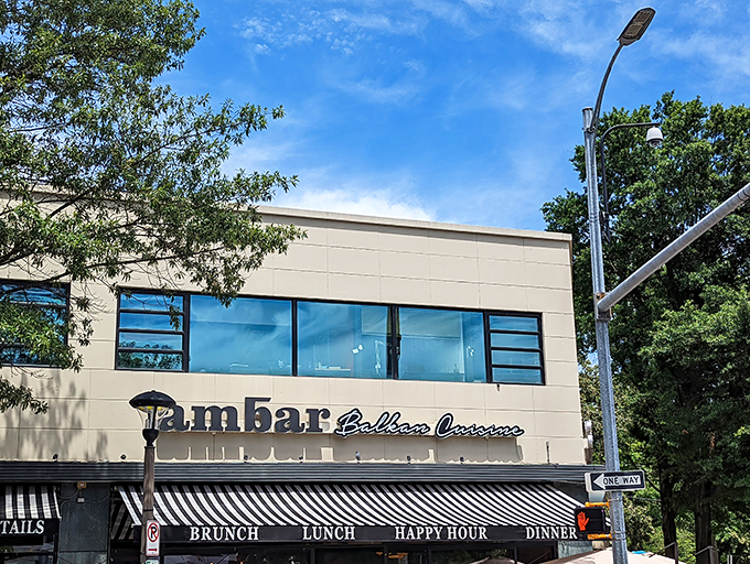 AMBAR's sleek exterior beckons from its Clarendon corner, promising Balkan delights within. Those outdoor tables? Prime real estate for people-watching while sipping rakija.