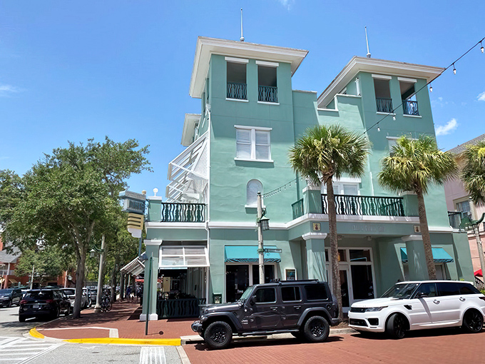 The mint-green facade of Downtown Diner stands like a tropical oasis in Celebration, inviting hungry travelers with its charming balconies and Florida flair.