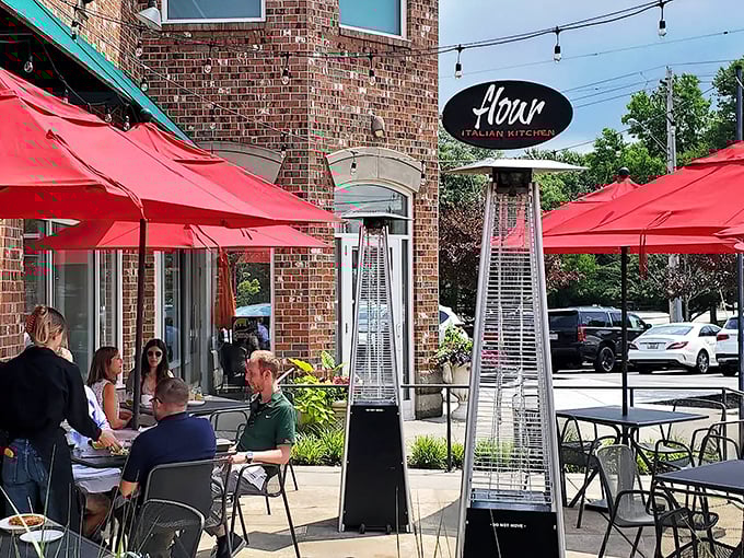 Flour's distinctive brick exterior with its elegant oval sign promises Italian delights within. Those red umbrellas aren't just for show&mdash;they're inviting you to linger over aperitivos on warm Ohio evenings.