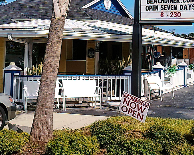 The cheerful yellow exterior with blue accents feels like Florida sunshine in building form. That "OPEN" sign is practically begging you to come in.