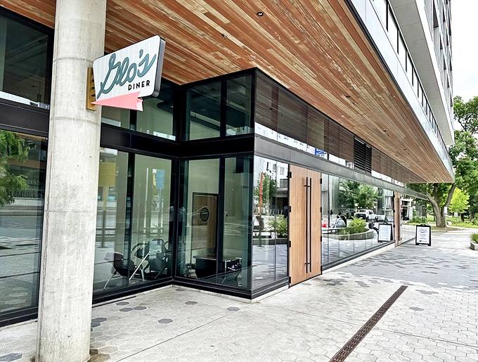 Glo's iconic green neon sign welcomes hungry patrons to their newer Capitol Hill location, where breakfast dreams come true regardless of Seattle's notorious weather.