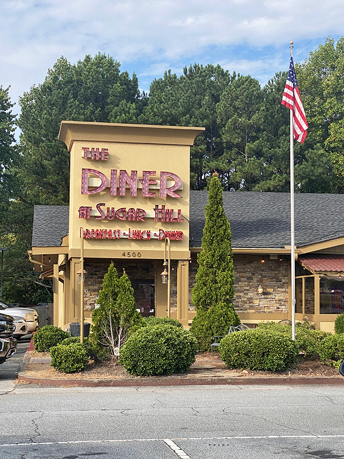 The beige and stone exterior might not scream "culinary destination," but that American flag signals what's inside: honest-to-goodness, no-nonsense American comfort food that delivers.
