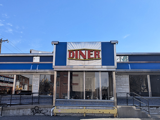 The iconic blue exterior of Broad Street Diner stands like a beacon of breakfast hope on a Philadelphia street corner, promising comfort food salvation to hungry travelers.