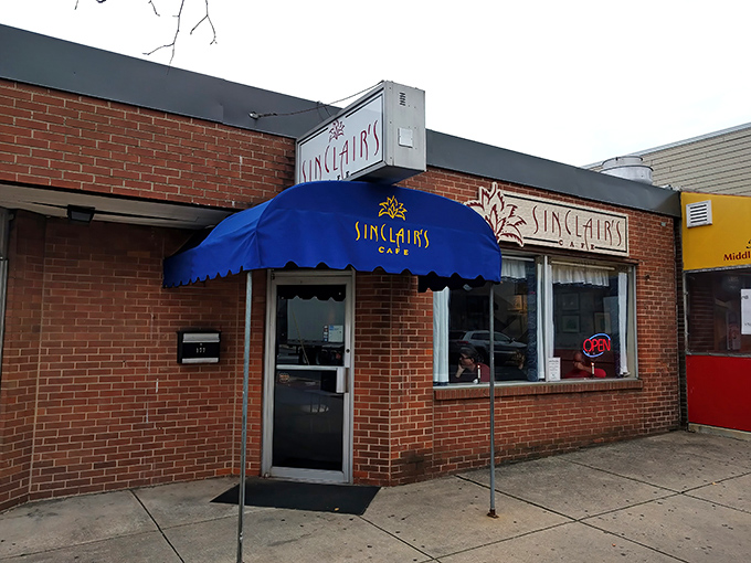 The iconic blue awning of Sinclair's Cafe stands out like a beacon for breakfast enthusiasts in Newark, promising comfort food salvation just steps away.