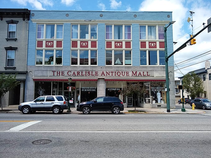 The striking blue facade of Carlisle Antique Mall stands like a time portal on Hanover Street, beckoning treasure hunters with promises of yesteryear's finest forgotten wonders.