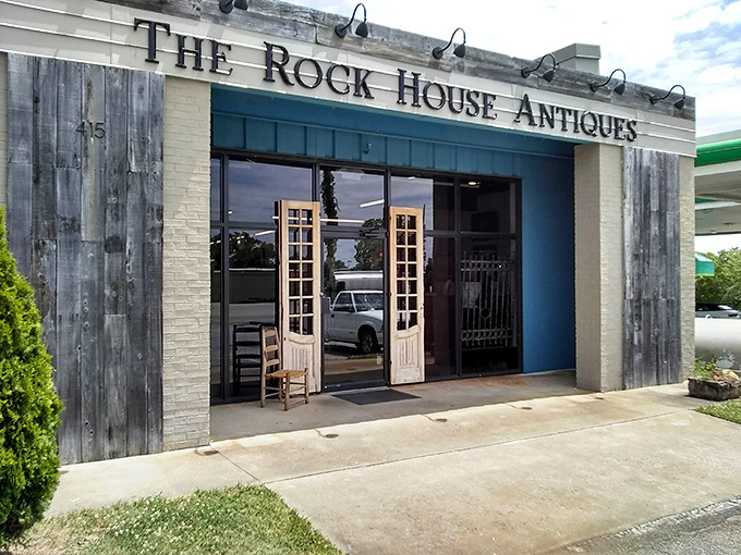 The weathered wood facade and vintage French doors of The Rock House Antiques promise treasure hunting adventures that would make Indiana Jones jealous.