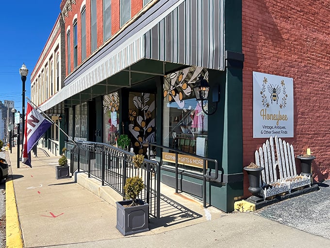 The striped awning and golden bee logo beckon like an old friend waving you over for coffee and gossip about treasures inside.