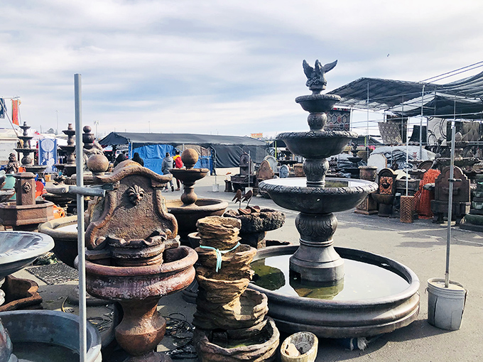 Garden fountains and stone sculptures create an unexpected oasis amid the market chaos. Who knew your backyard needed a three-tiered masterpiece?