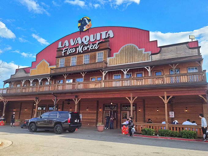 The iconic red barn facade of La Vaquita stands like a beacon for bargain hunters, promising treasures within its Western-styled walls.