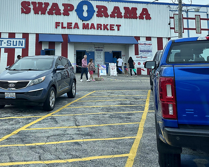 The red and white exterior of Swap-O-Rama beckons like a carnival of commerce, promising treasures waiting to be discovered inside.