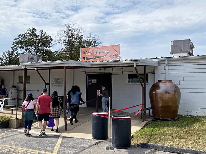 The entrance to treasure-hunting paradise! Shoppers eagerly file into the Wentzville Flea Market, where that giant pottery jar hints at the oversized possibilities within.