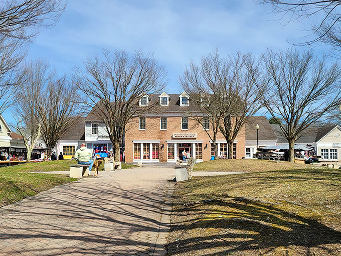 The colonial-style brick building houses treasure hunting adventures beneath its dormer windows, while outdoor vendors create a festive marketplace atmosphere under the summer sky.