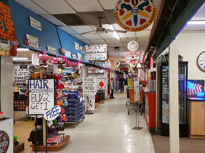 The colorful Q-Mart logo hangs proudly overhead as shoppers navigate corridors filled with treasures waiting to be discovered.