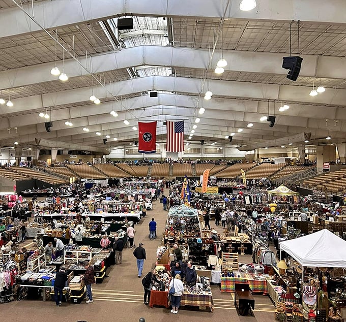 The arena transforms into a treasure hunter's paradise where thousands gather under Tennessee and American flags, proving one person's clutter creates another's joy.