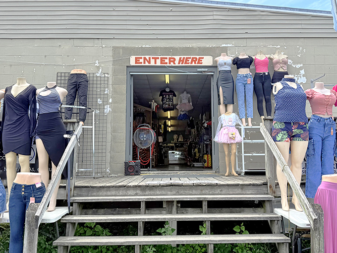 The "ENTER HERE" sign might as well say "Abandon all shopping restraint, ye who enter." Mannequins stand guard like sentinels of style at this treasure-filled gateway.