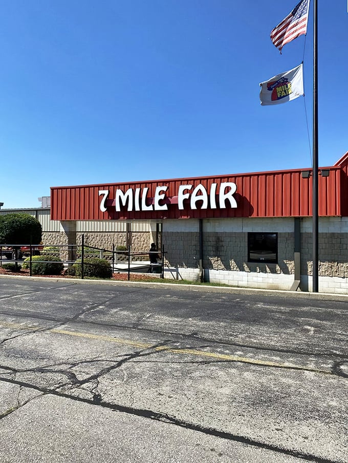 The iconic red exterior of 7 Mile Fair stands like a retail Emerald City, beckoning bargain hunters with promises of treasures within.