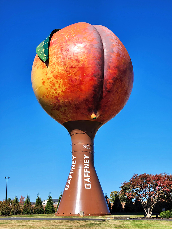 The Peachoid stands proudly against a brilliant blue sky, its unmistakable shape causing double-takes from Interstate 85 travelers since 1981.