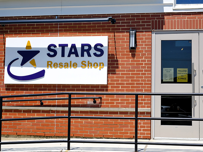 The charming brick facade of STARS Resale Shop welcomes bargain hunters with its distinctive blue and yellow signage, promising treasures waiting to be discovered inside.