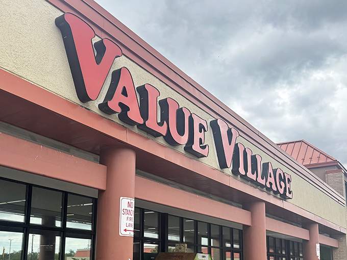 The iconic red Value Village sign beckons like a lighthouse guiding bargain hunters to shores filled with secondhand treasures and unexpected finds.