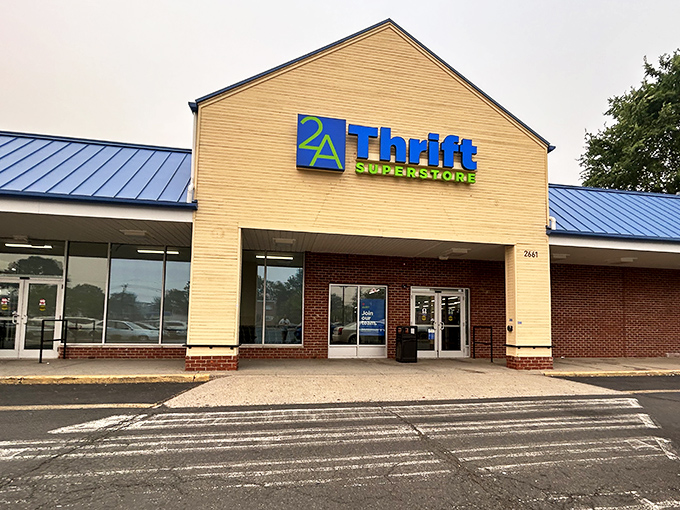 The beige and brick exterior of 2nd Ave Thrift Superstore stands like a temple to secondhand treasures, its blue and green sign beckoning bargain hunters.