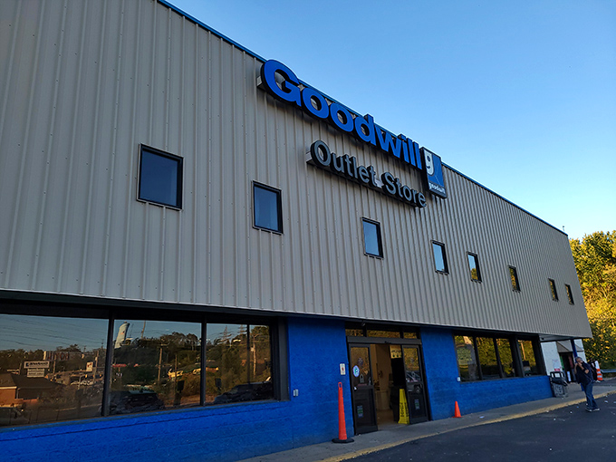 The blue-trimmed facade of Goodwill's Outlet Store stands like a treasure chest waiting to be unlocked, promising adventures in bargain hunting beyond those automatic doors.