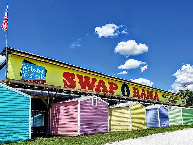 The colorful entrance to Swap-O-Rama beckons treasure hunters with its rainbow of vendor stalls and promise of discoveries waiting just beyond those pastel sheds.