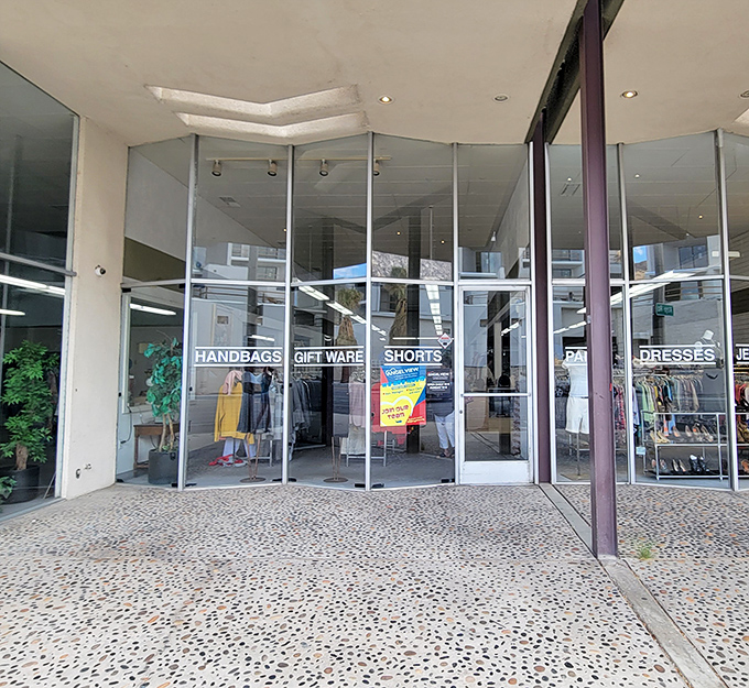 The terrazzo-speckled entrance beckons with promises of hidden treasures. Palm Springs' architectural flair meets thrift store magic at Angel View's downtown location.