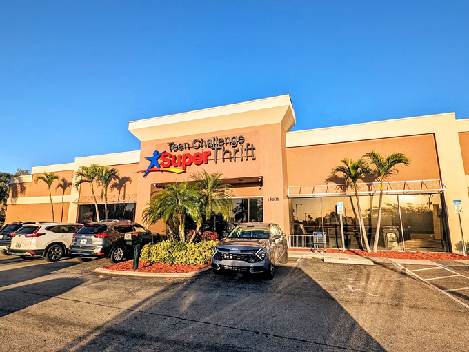 The pink stucco exterior of Teen Challenge SuperThrift stands like a beacon of bargain possibilities, palm trees included at no extra charge.