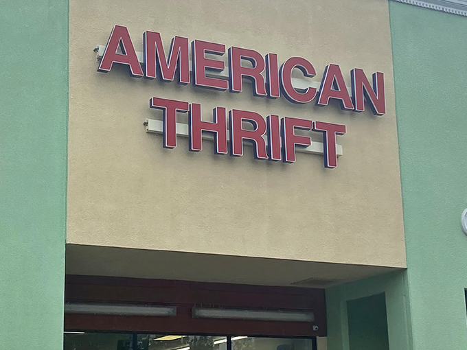 The mint-green facade of American Thrift Store beckons bargain hunters with its bold red signage, promising treasures within that won't break the bank.