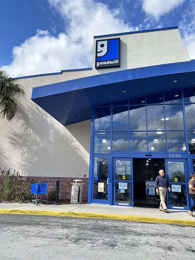 The iconic blue and white Goodwill facade welcomes bargain hunters under Florida's endless sky. Thrift paradise awaits!