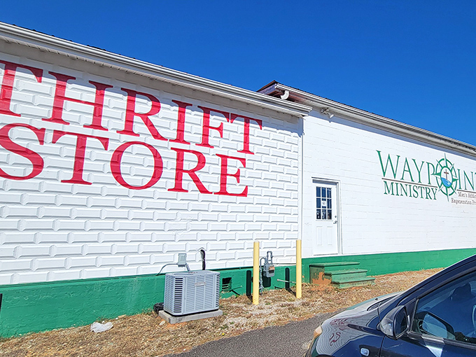 The white brick building with bold red lettering announces itself without pretense &ndash; treasure hunting starts here at Waypoint Thrift Store.