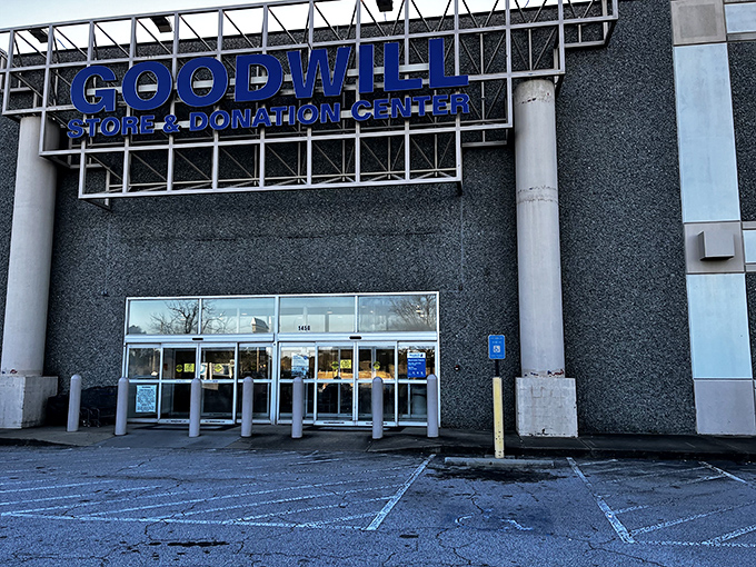 The blue Goodwill sign stands like a beacon of bargain hope against the gray building&mdash;retail therapy without the retail prices.